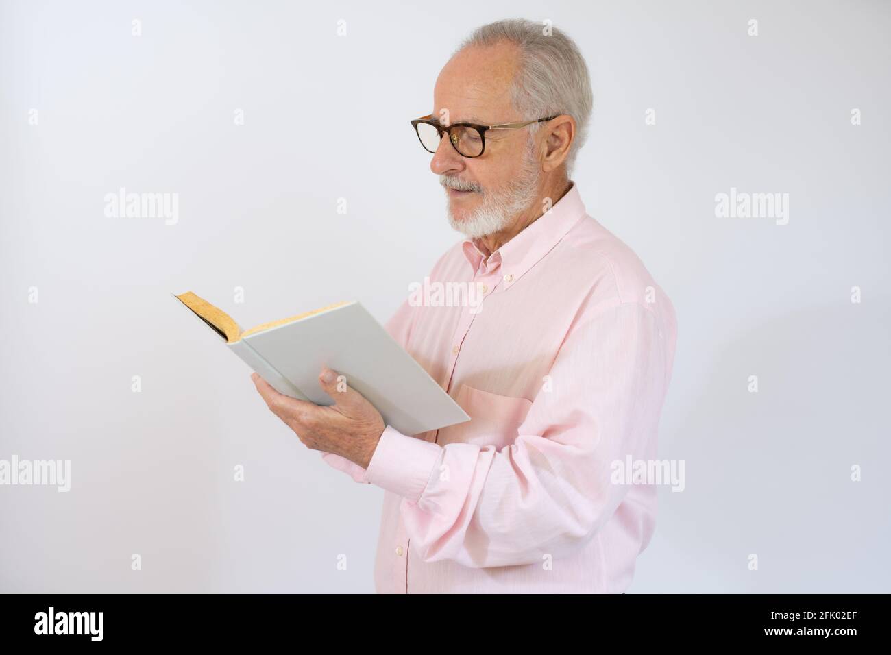 Studio shot of a senior man reading a book on white background Stock ...