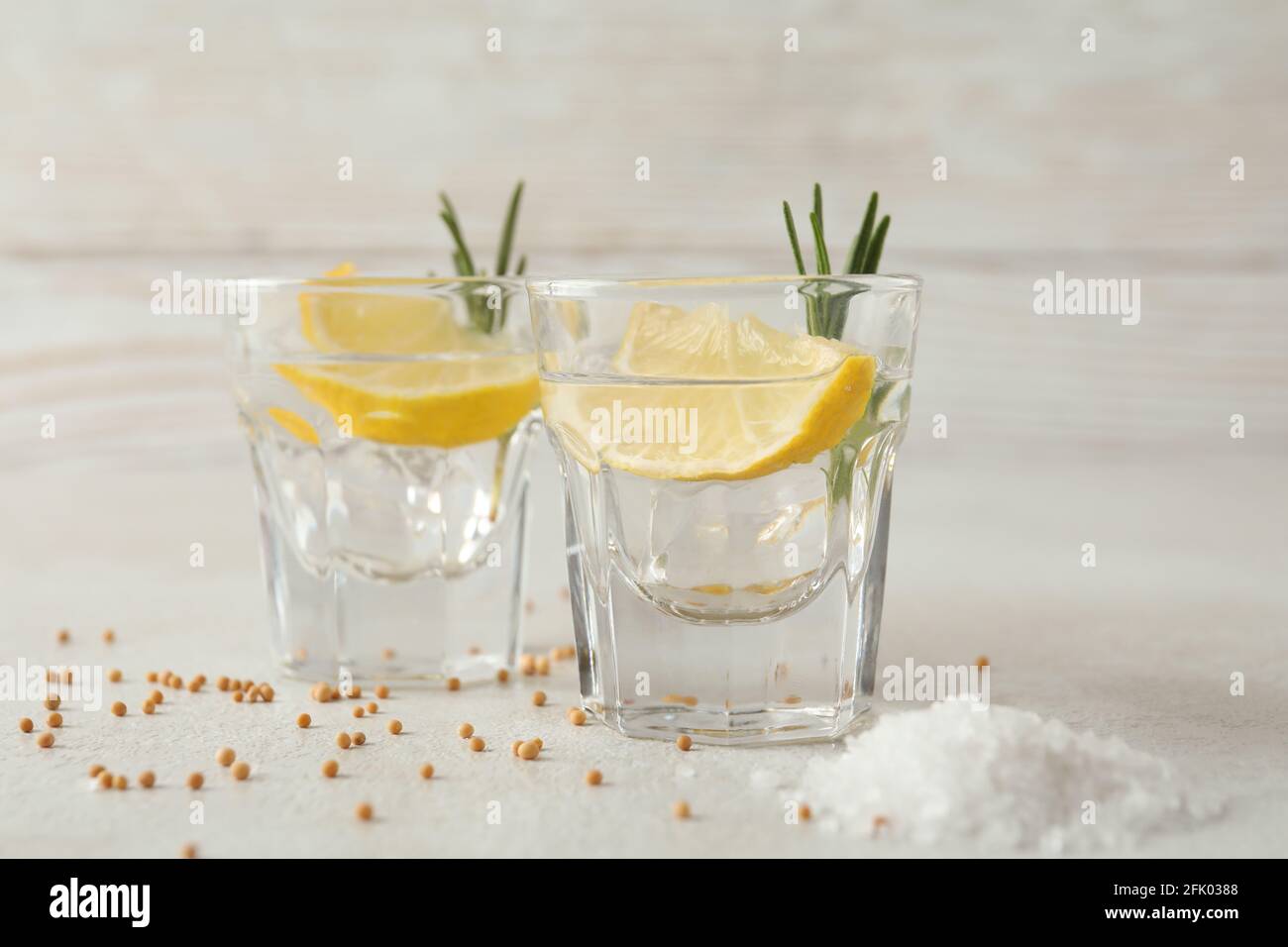 Shots of tequila on white textured table Stock Photo - Alamy