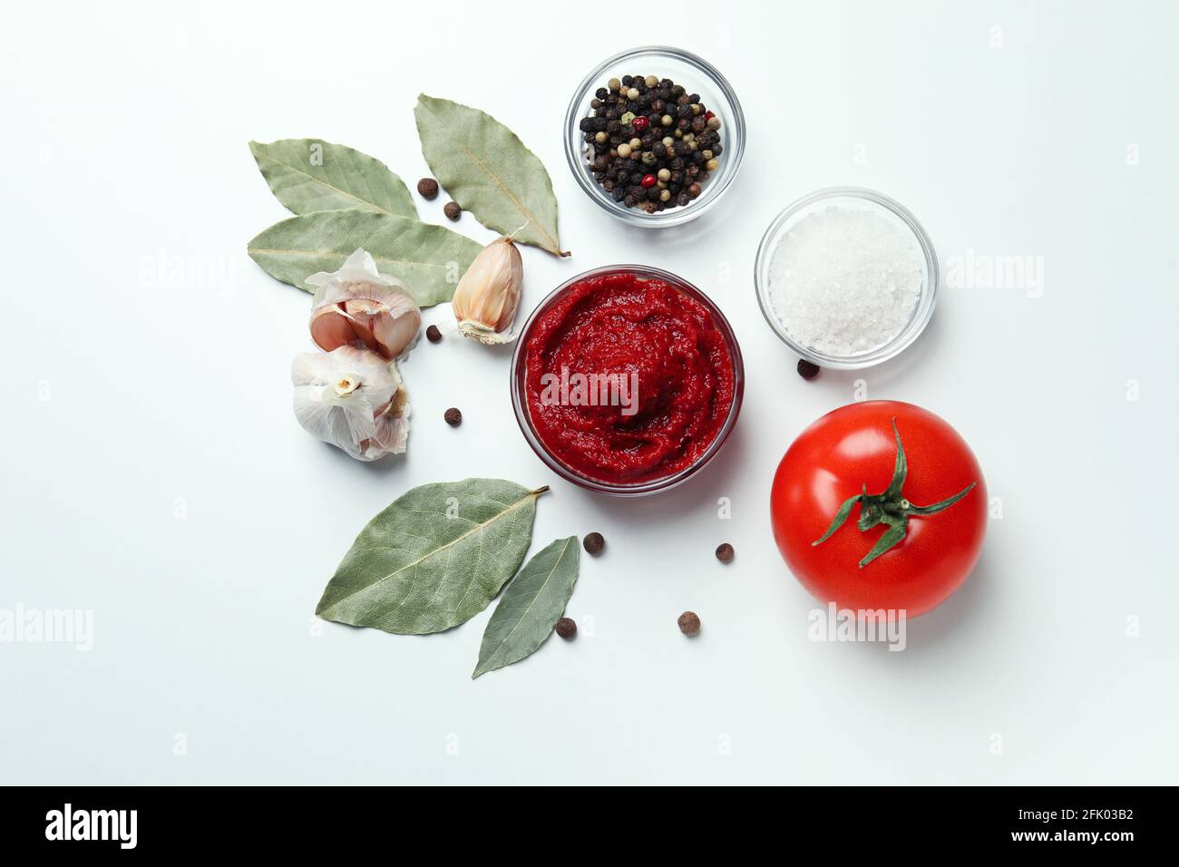 Bowl with tomato paste on white background with ingredients Stock Photo ...