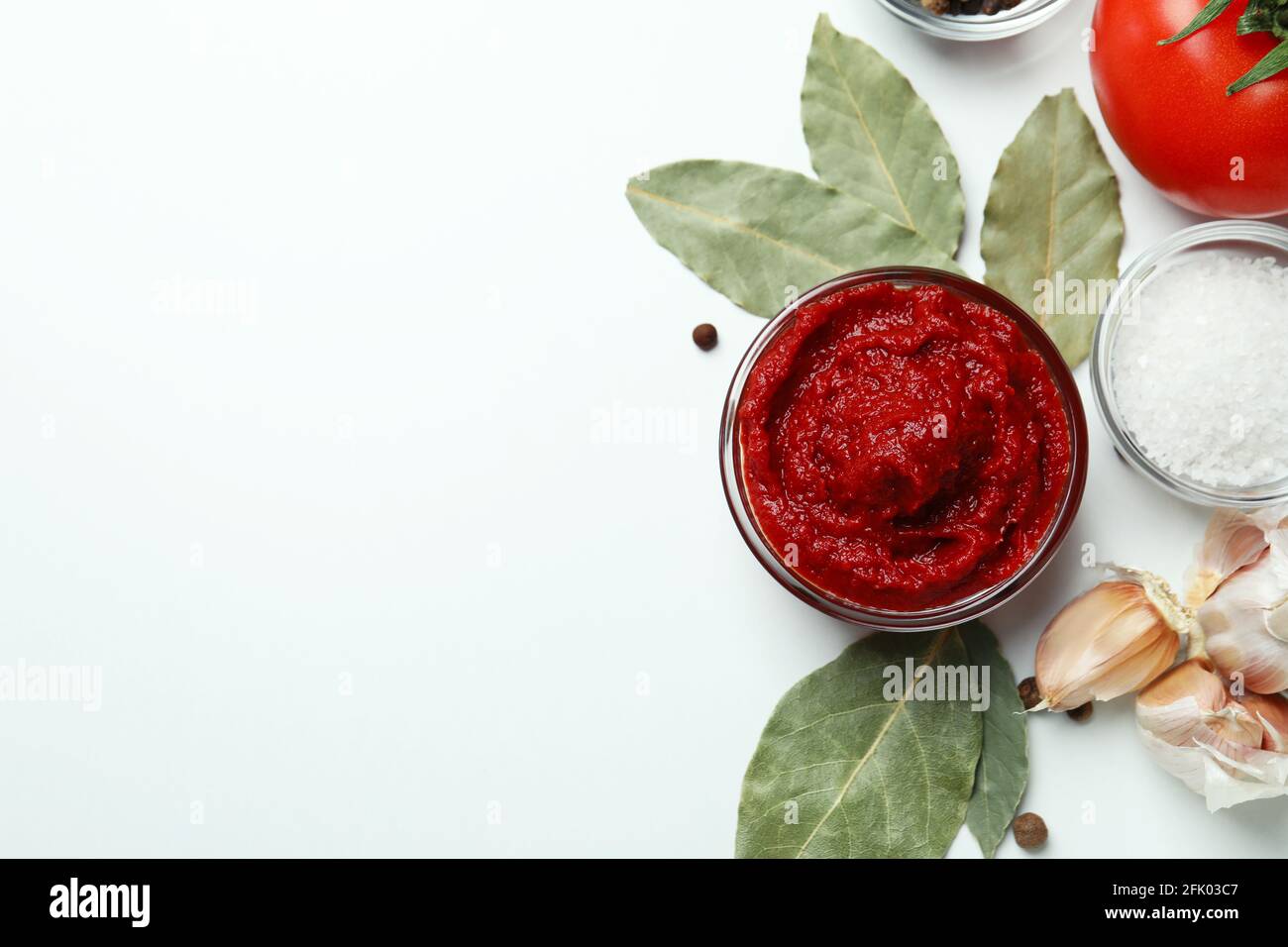 Bowl with tomato paste on white background with ingredients Stock Photo ...