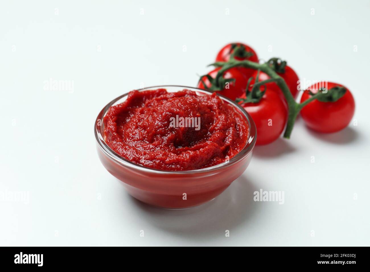 Bowl of tomato paste and tomatoes on white background Stock Photo - Alamy
