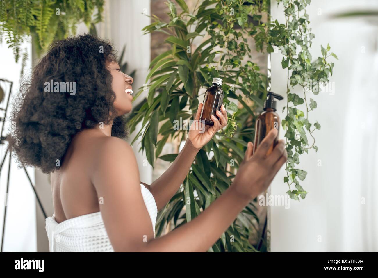 Woman choosing shampoo products hi-res stock photography and images - Alamy
