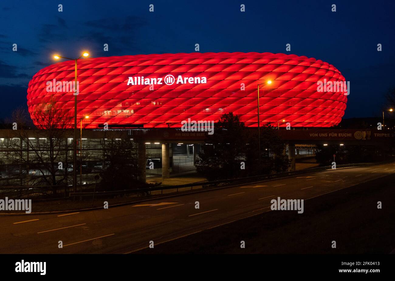Munich, Germany. 20th Apr, 2021. The Allianz Arena lights up during the ...