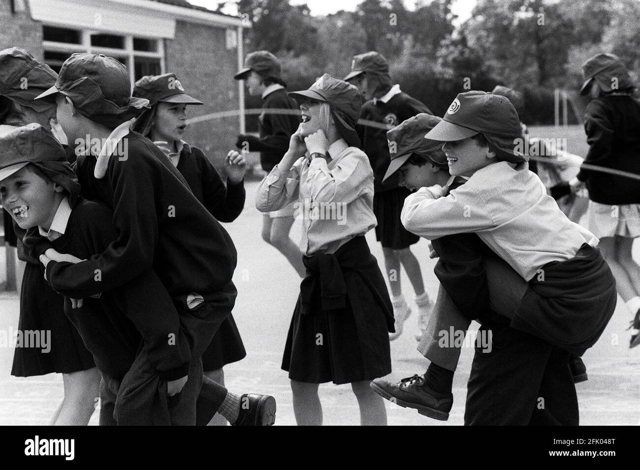 Some young lively schoolgirls go wild in the playground at break ...