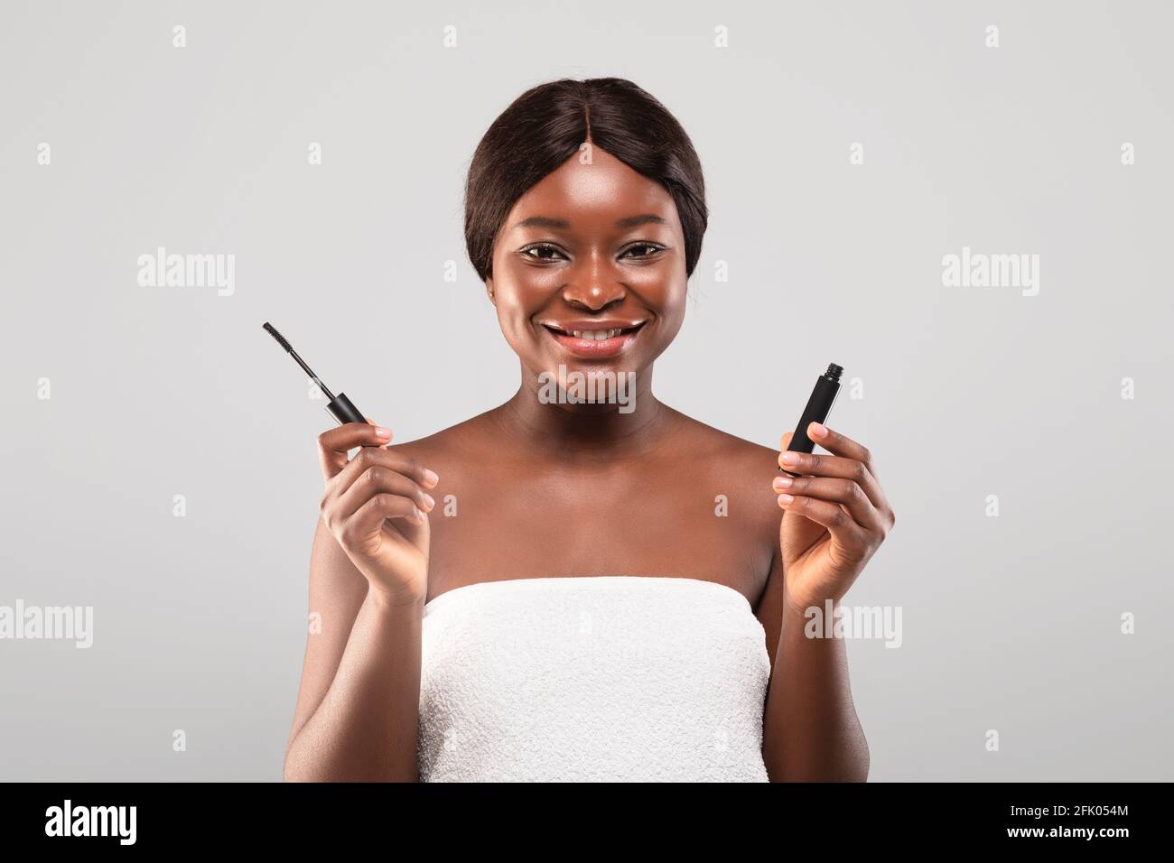 Portrait Of Beautiful African American Woman Holding Opened Mascara In ...