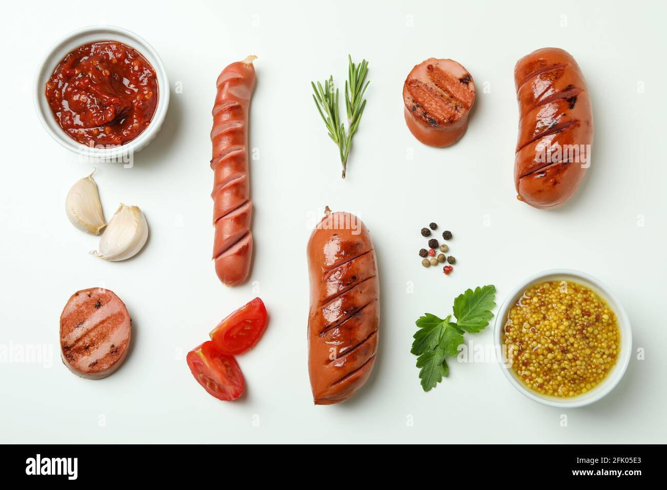 Grilled sausage, sauces and spices on white background Stock Photo - Alamy