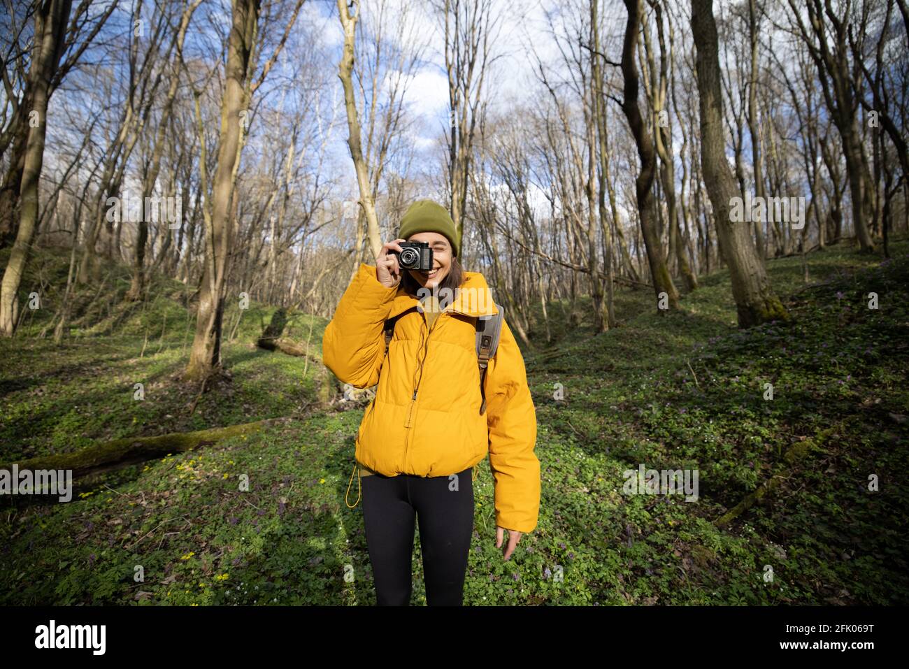 Woman in hiking clothes with backpack covered her face with a vintage ...