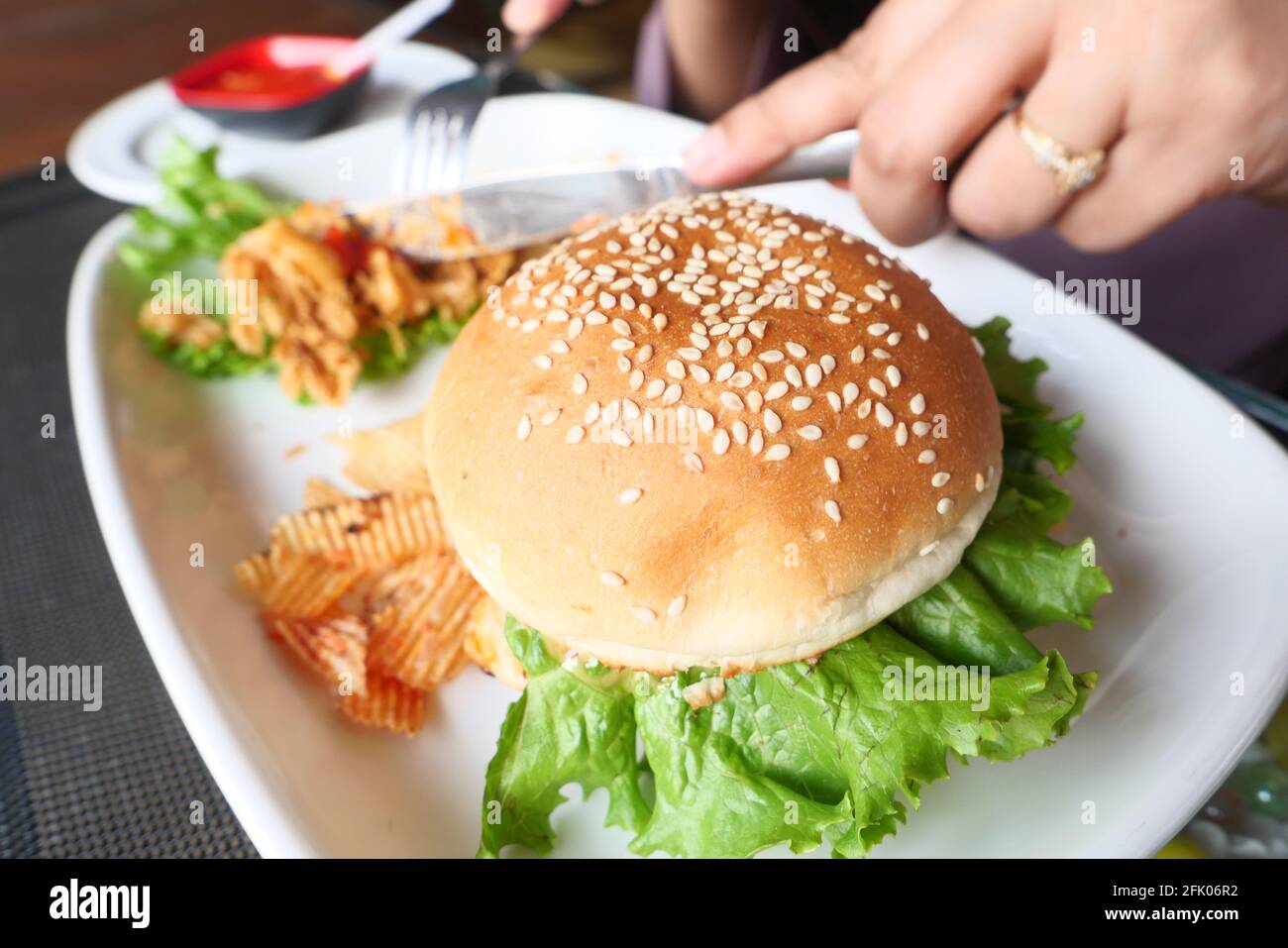 half eaten beef burger on table close up Stock Photo - Alamy