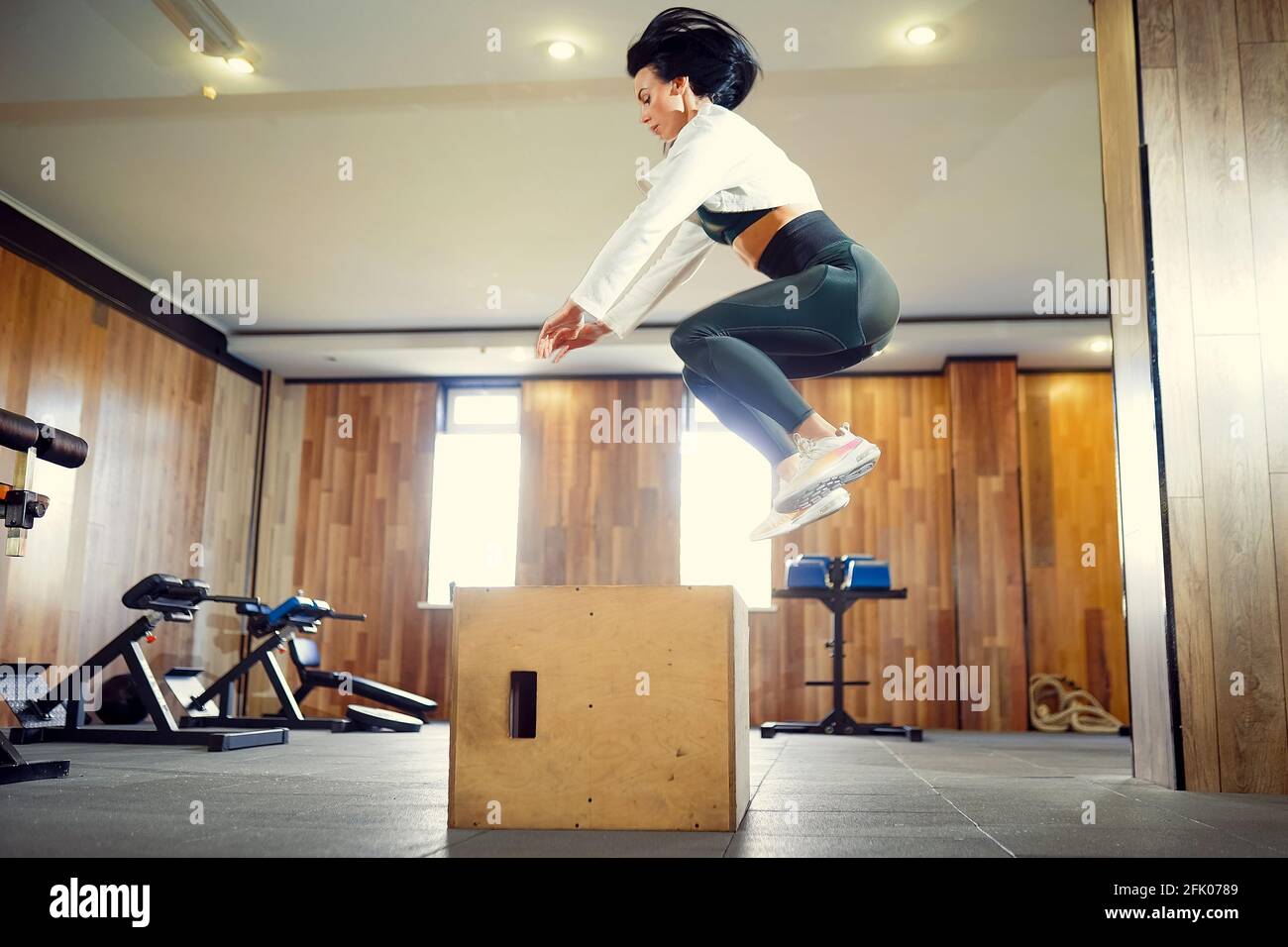 Shot of young woman working out with a box at the gym. Female at Stock ...
