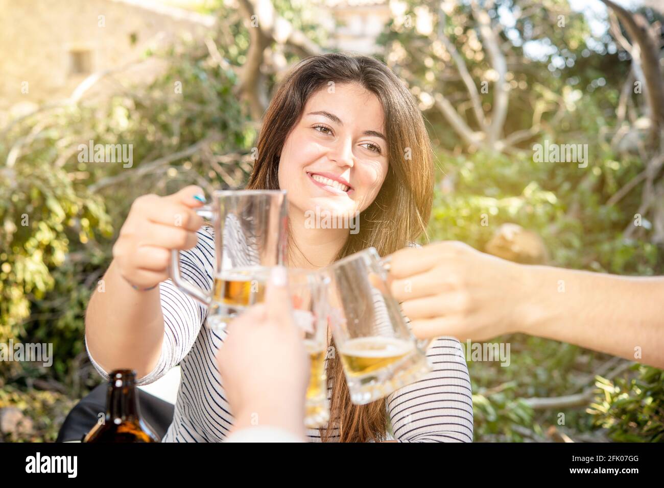 group of people toasting with beer outdoors Stock Photo - Alamy