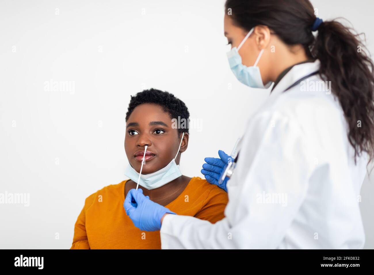 Covid-19 Virus Diagnostic. Professional Nurse Testing Black Lady For ...