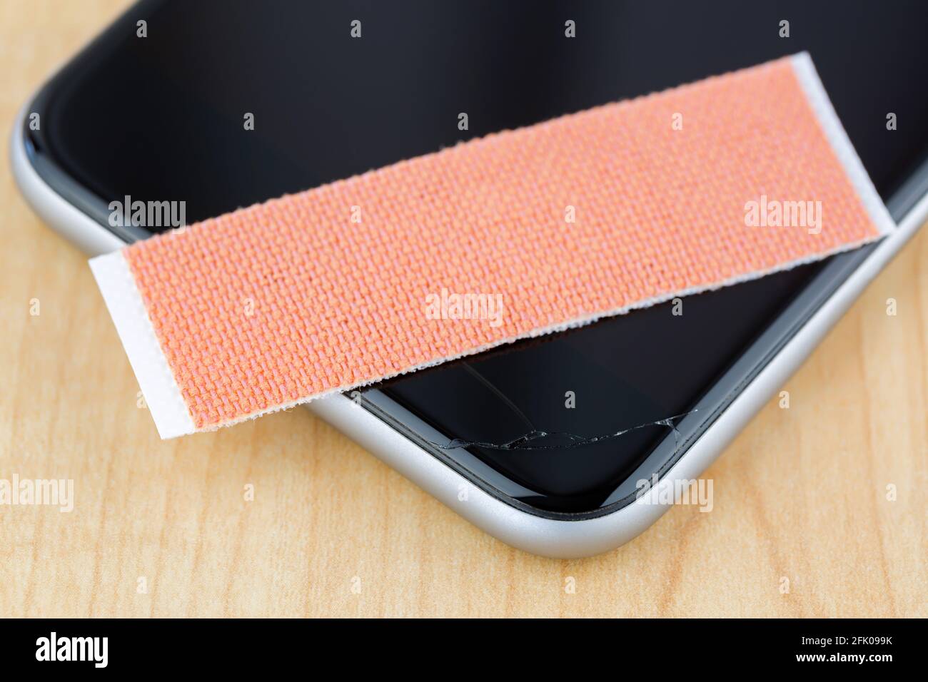 Extra strong fabric plaster on broken smart phone with cracked screen ...