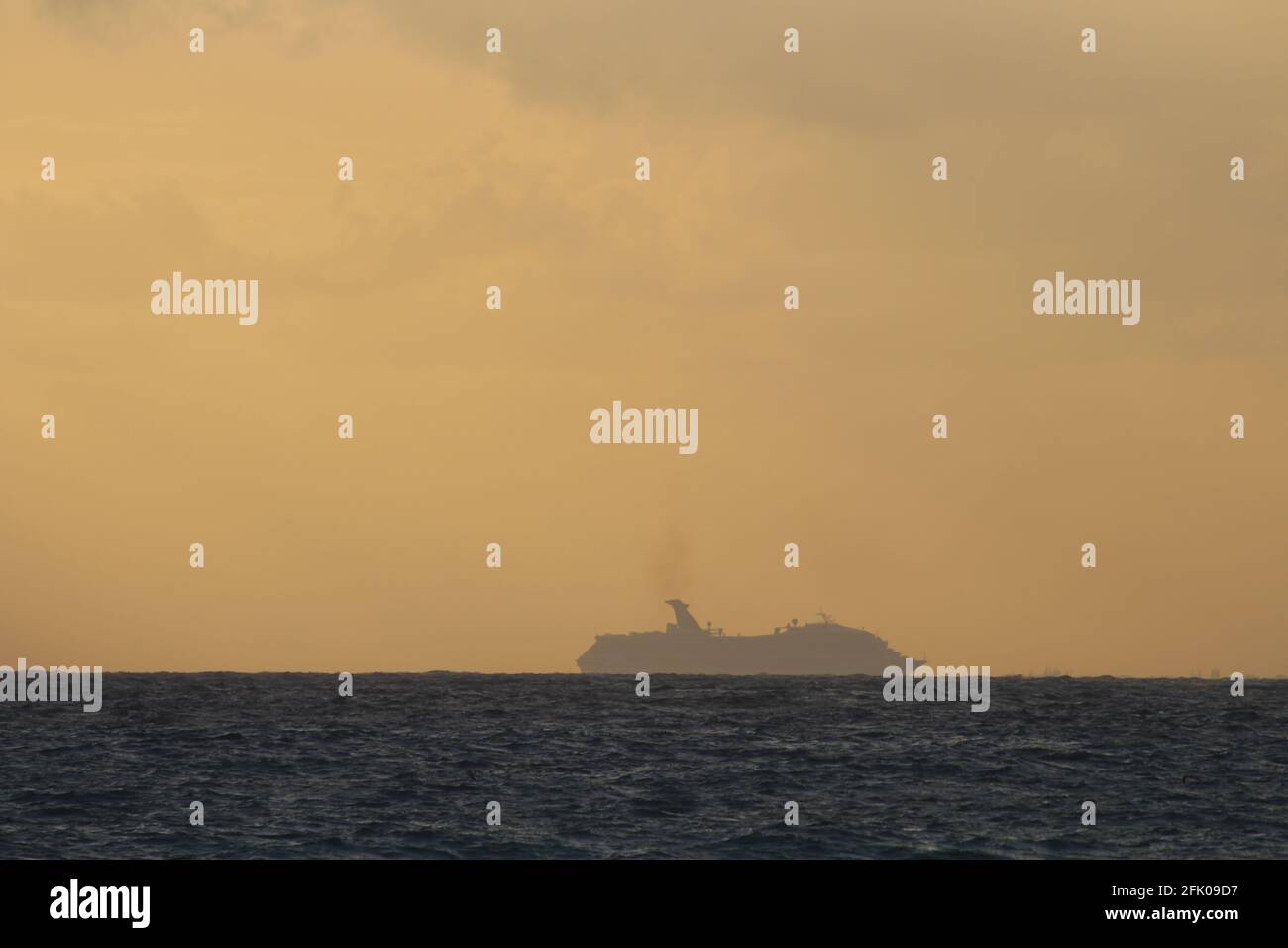 ship in the distance at a beautiful sunset Stock Photo - Alamy