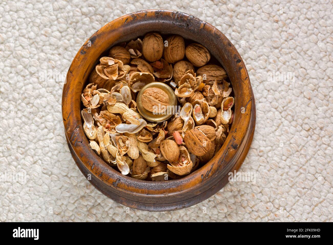 Walnut on brass in vintage wooden nut bowl with cracked walnut and ...
