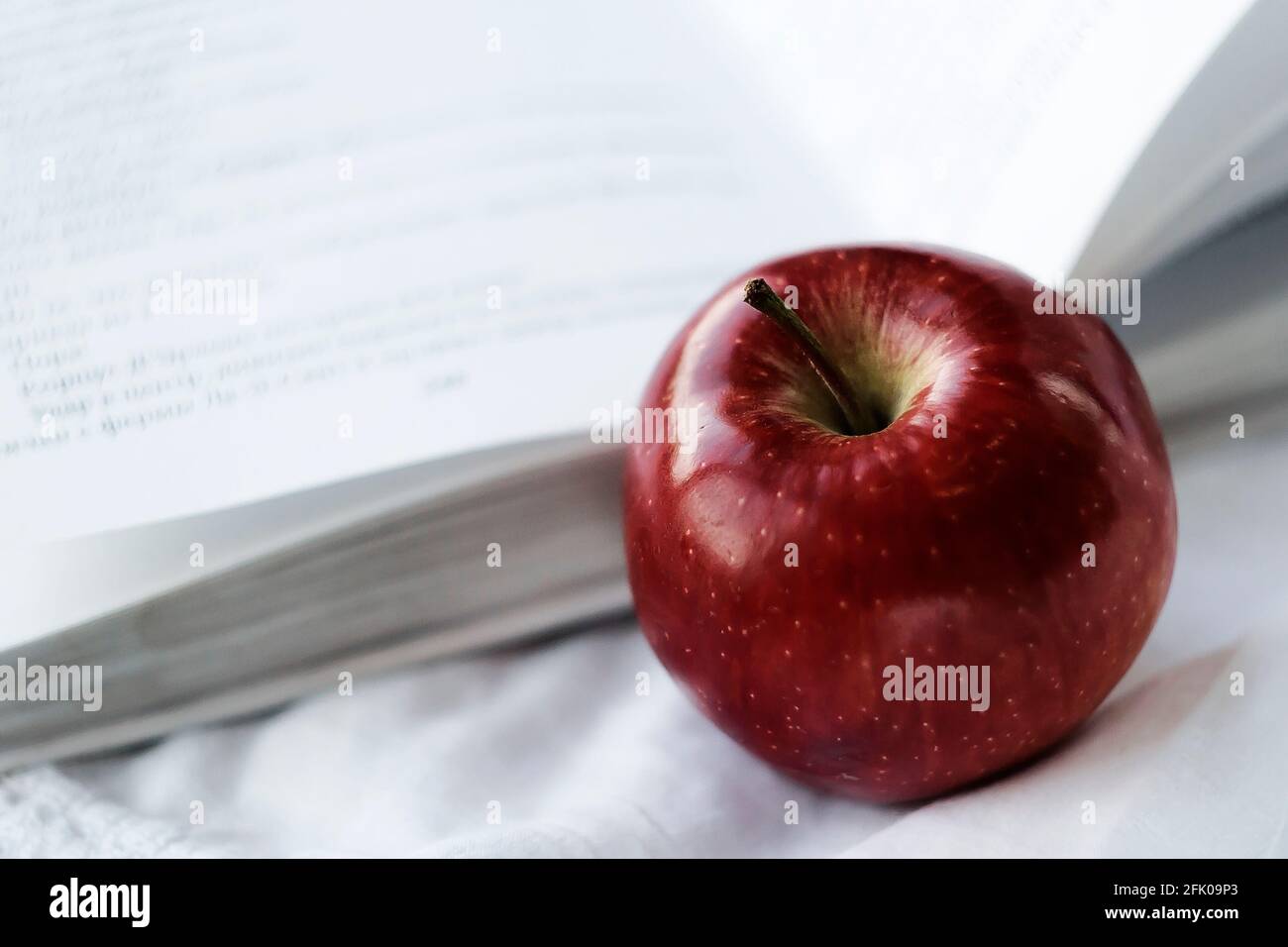 red apple on the background of the book. Photo Stock Photo - Alamy