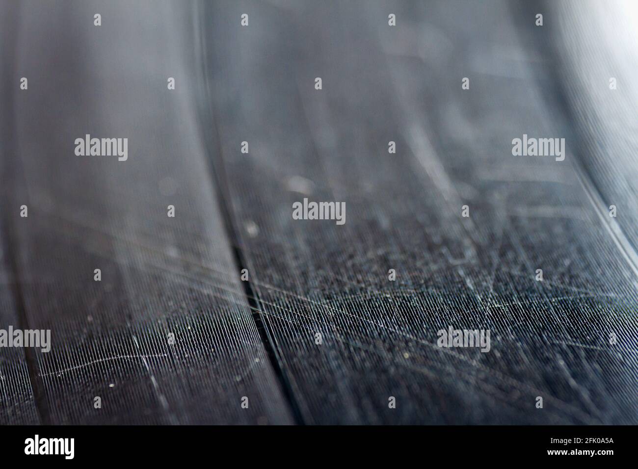 Macro shot of black vinyl record showing scratches. Surface of an old ...