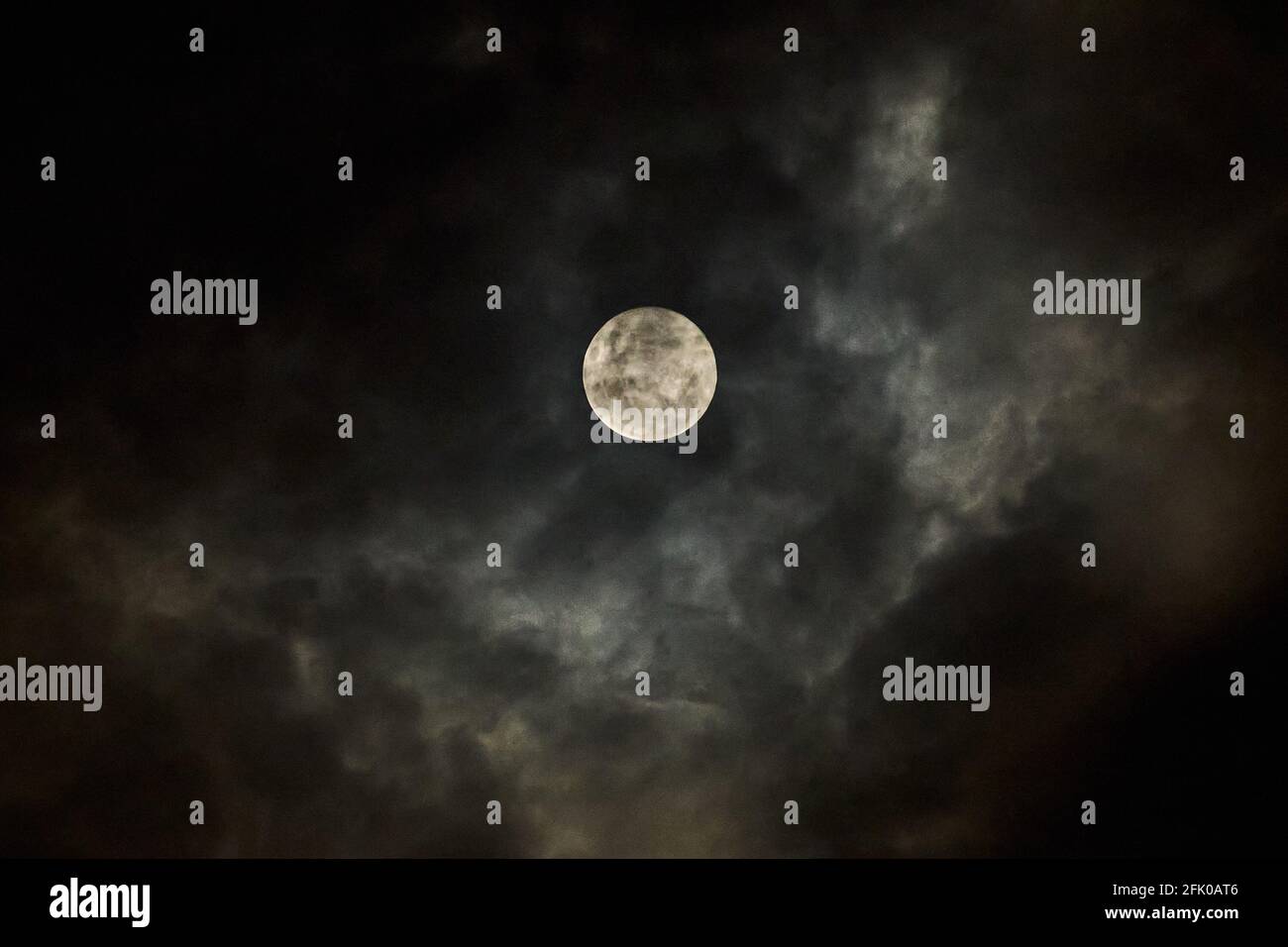 Pink Supermoon phenomenon seen through the clouds in Franca, Sao Paulo, Brazil, on April 26 ...
