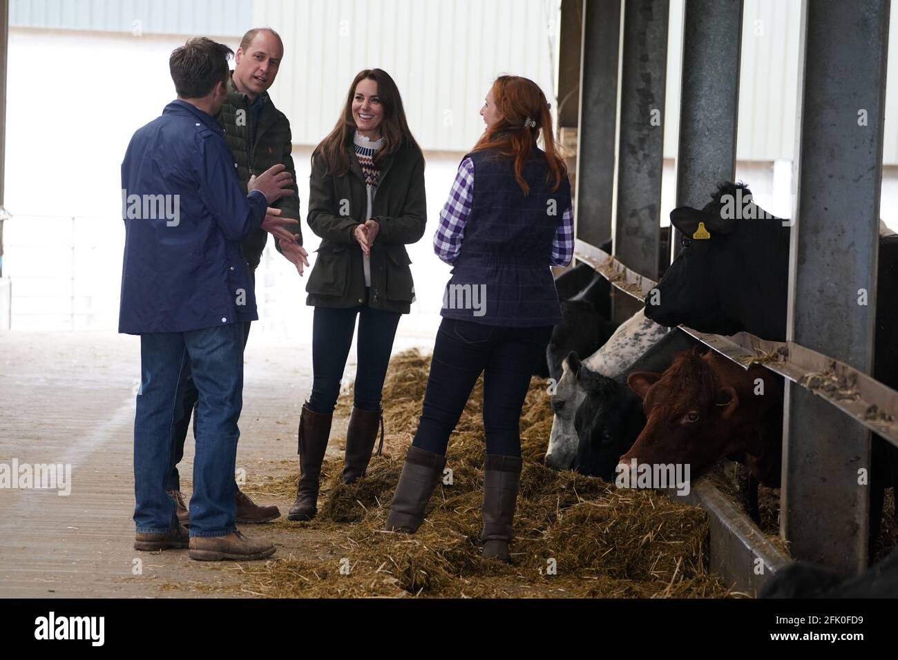 The Duke and Duchess of Cambridge (centre) are shown cattle by farmers ...