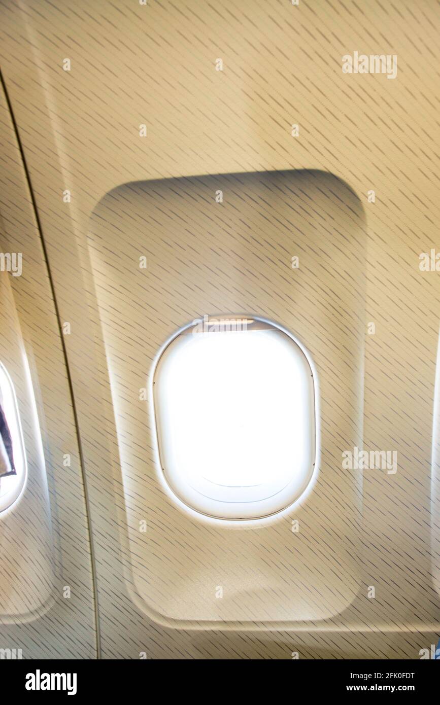 Airplane window with light coming in Stock Photo - Alamy