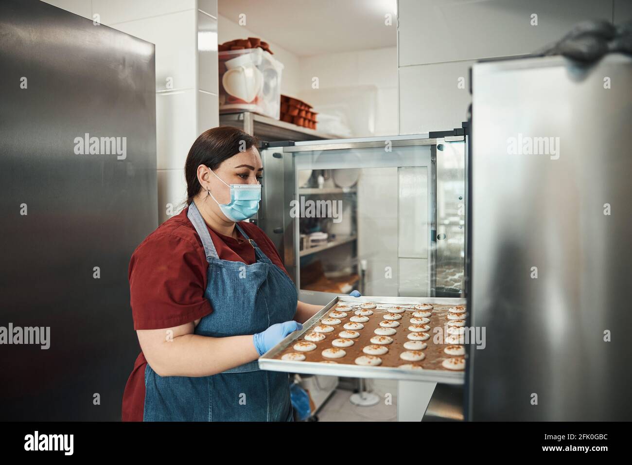 Female baker in uniform gloves hi-res stock photography and images - Alamy
