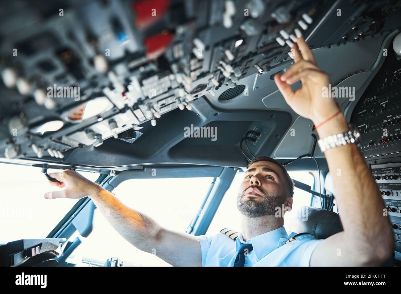 Calm handsome pilot preparing for the international flight Stock Photo ...