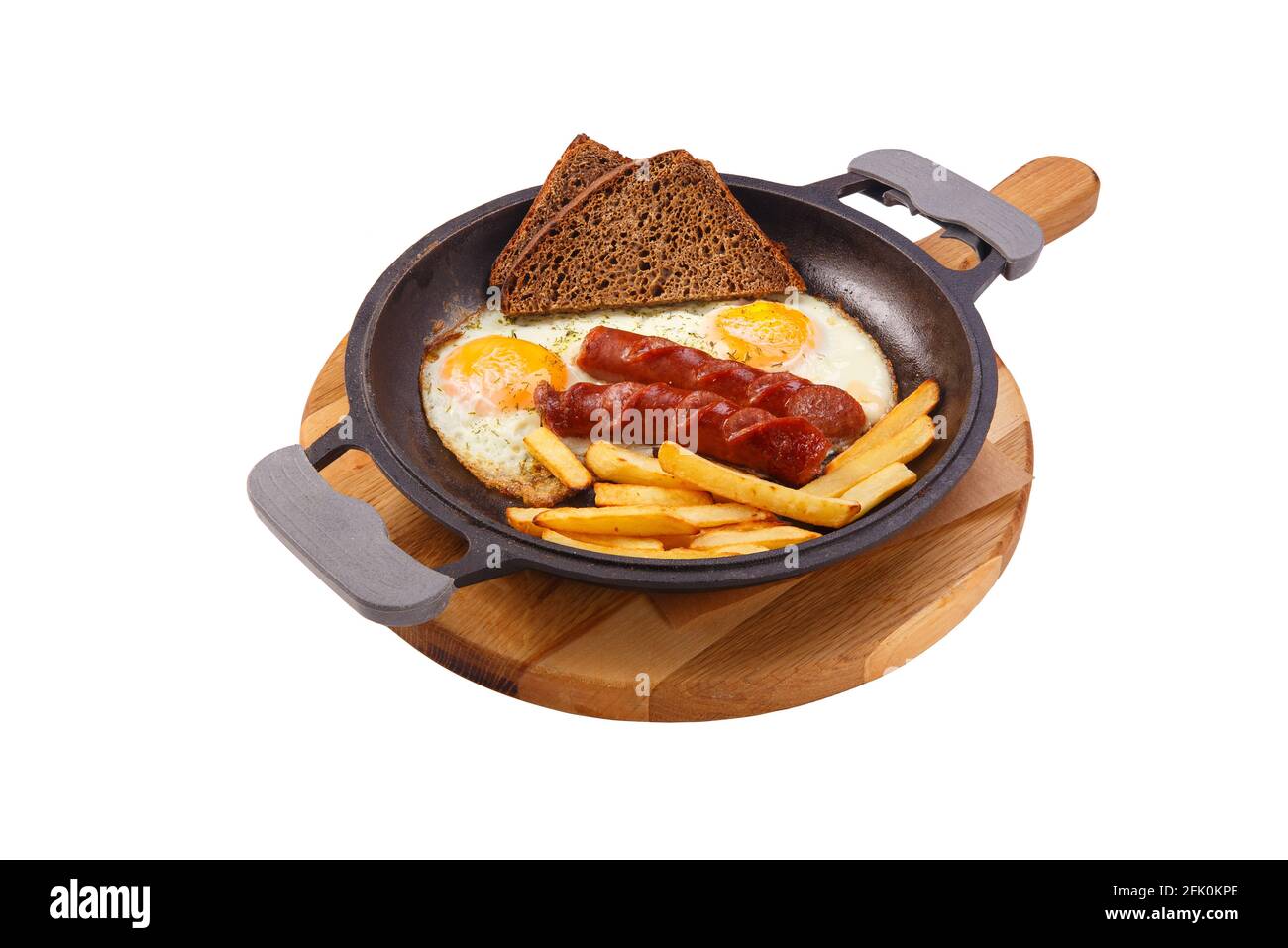 English breakfast in cooking pan with fried eggs, sausages, fries and ...