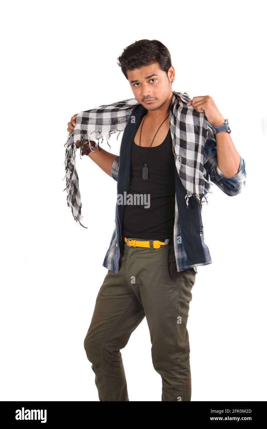 A stylish young Indian guy posting against a white studio backdrop ...