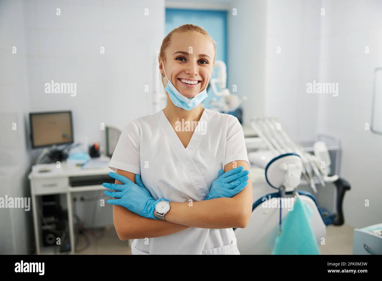 Cheerful doctor posing in her dental office for photo Stock Photo - Alamy