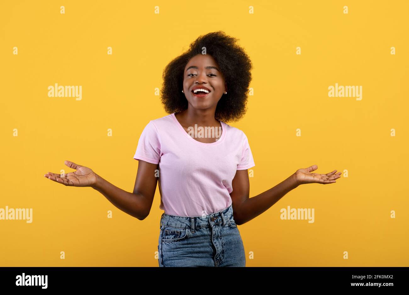 Excited african american woman shrugging shoulders and smiling to ...