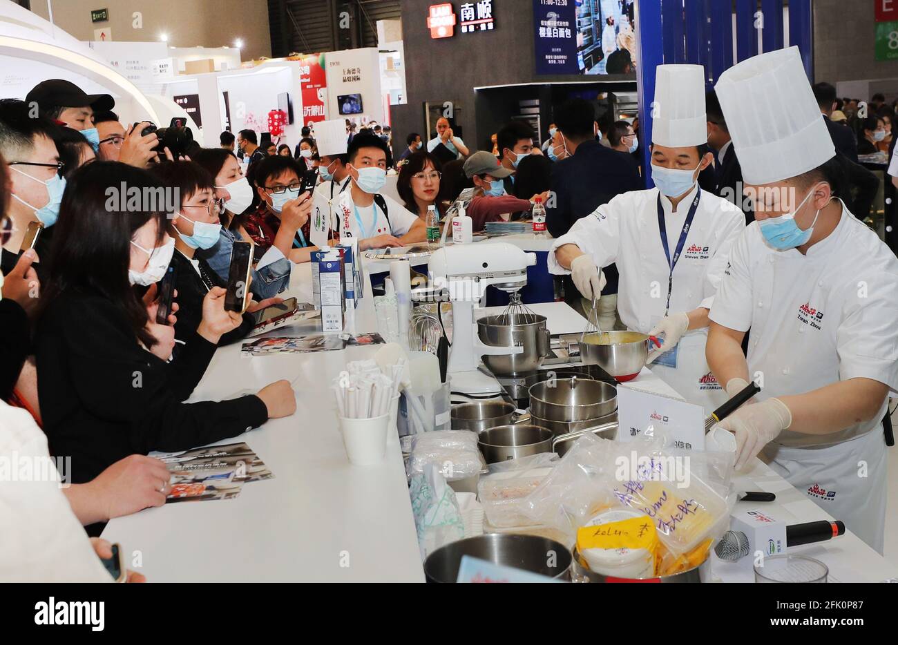 Shanghai. 27th Apr, 2021. Bakers demonstrate food processing techniques ...