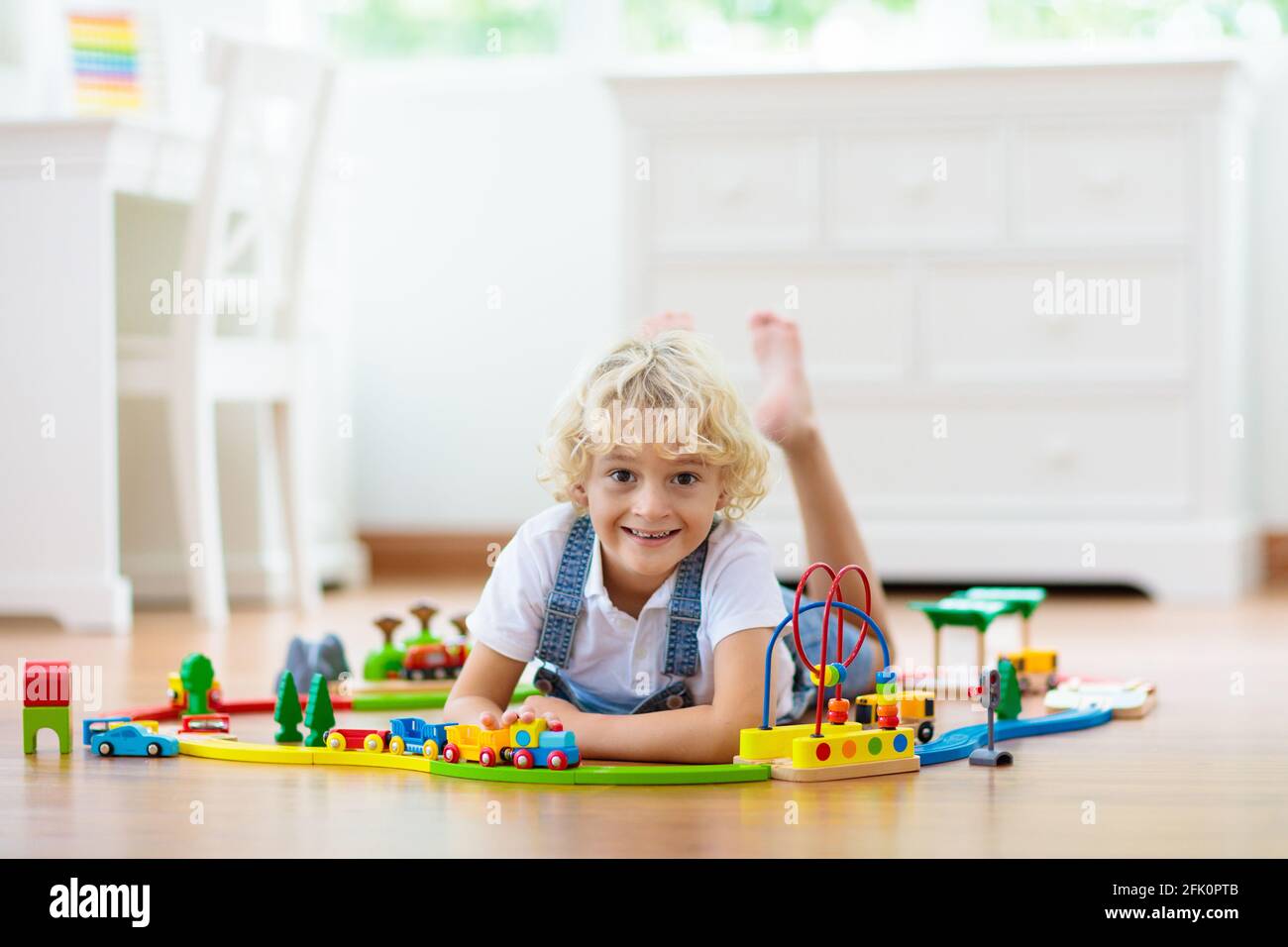 Kids play with wooden railway. Child with toy train. Educational toys ...