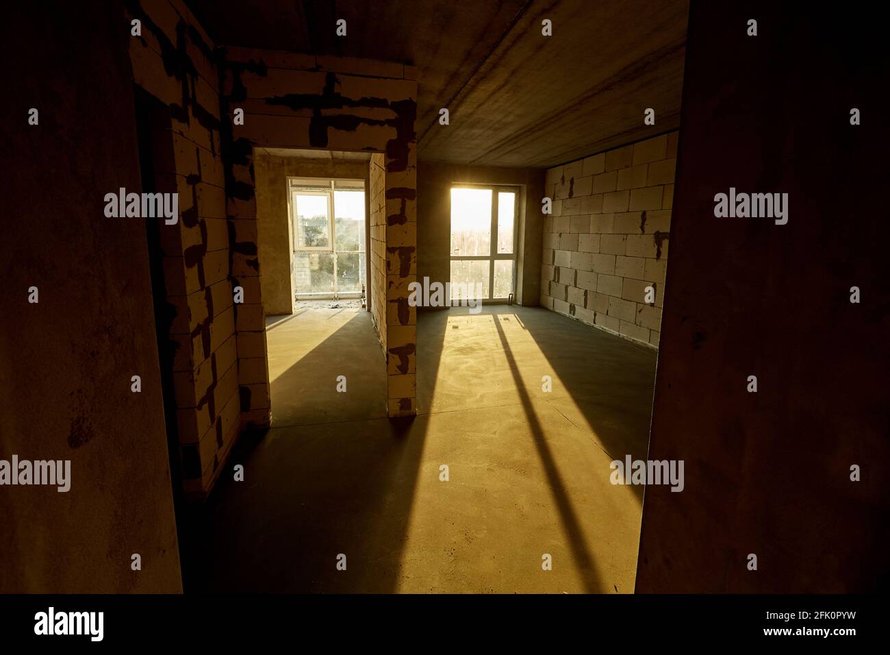 Unfinished empty flat, two huge plastic windows, walls made of aerated ...