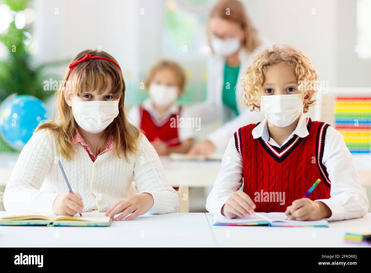 Kids in face mask in school class. Child back to school after ...