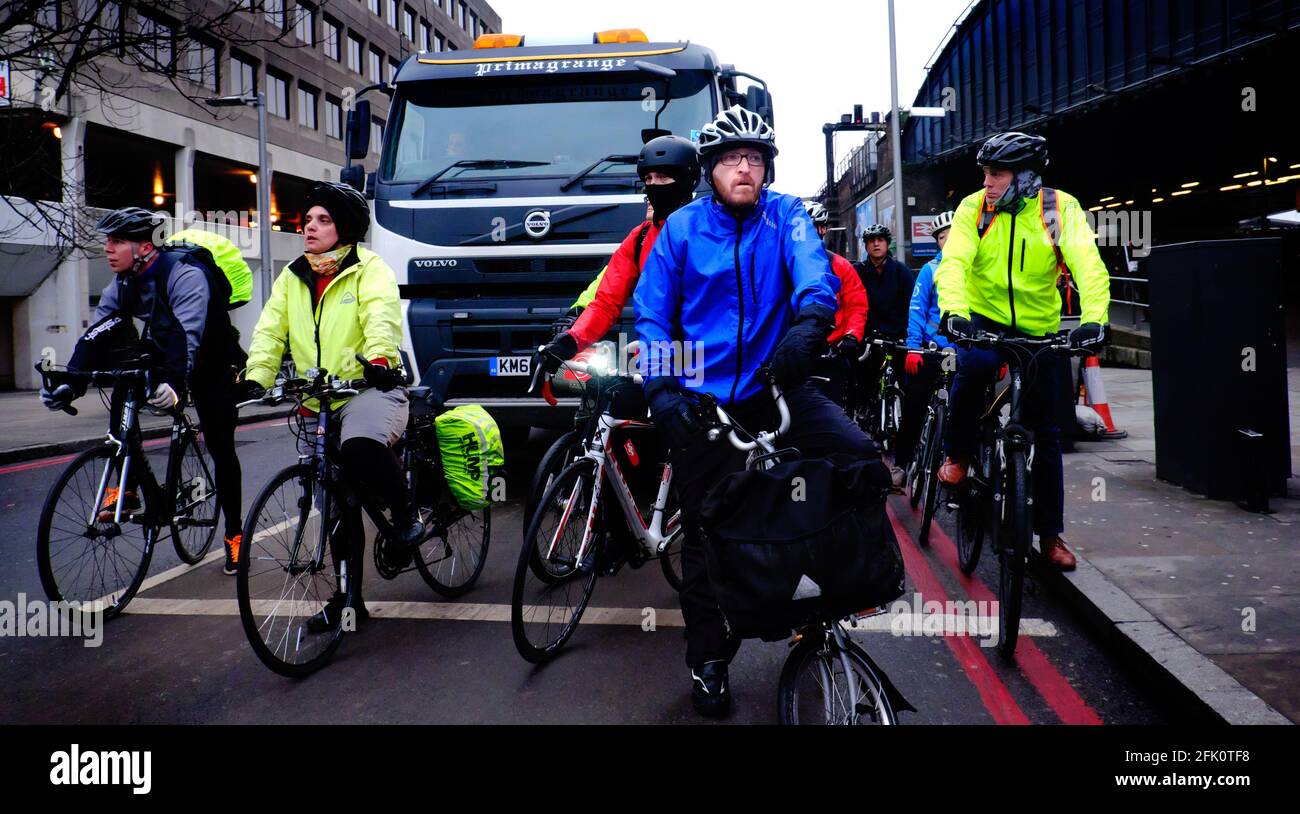 Cycling commuters wait at traffic lights with Stock Photo - Alamy