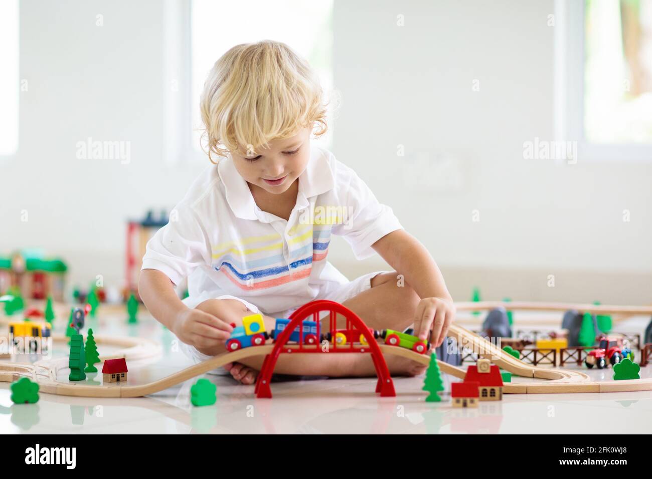 Kids play with wooden railway. Child with toy train. Educational toys ...