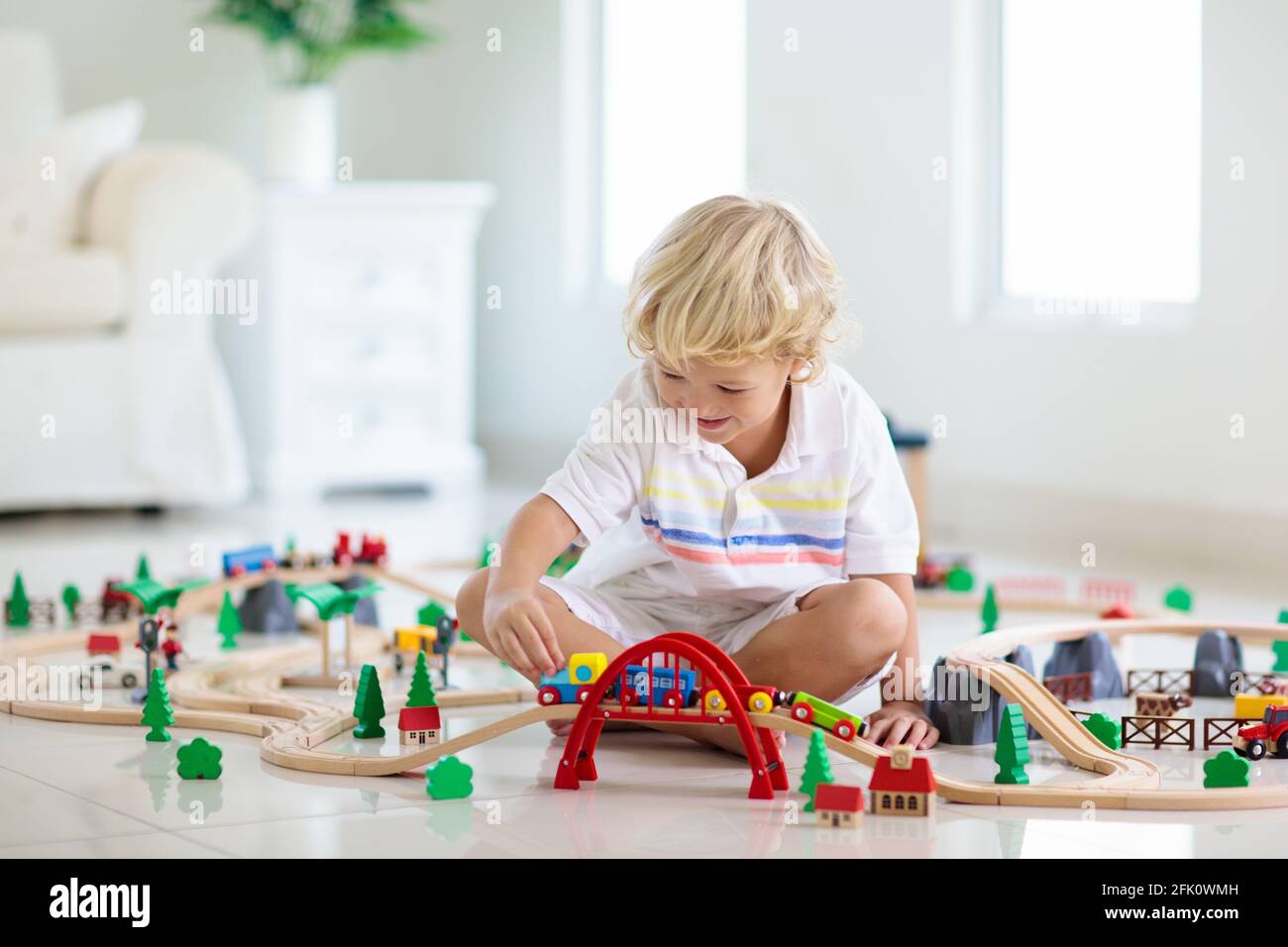 Kids play with wooden railway. Child with toy train. Educational toys ...
