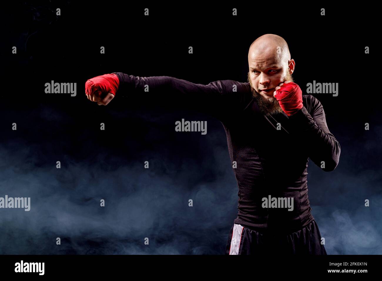 Sportsman boxer fighting on black background with smoke. Boxing Stock ...