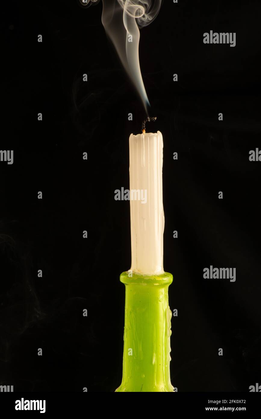 Single candle on black background smoke Stock Photo - Alamy
