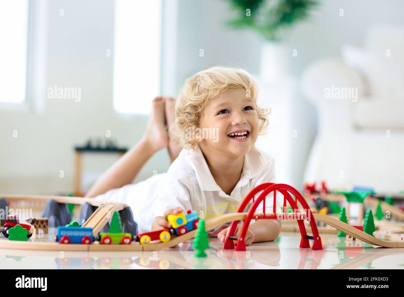 Kids play with wooden railway. Child with toy train. Educational toys ...