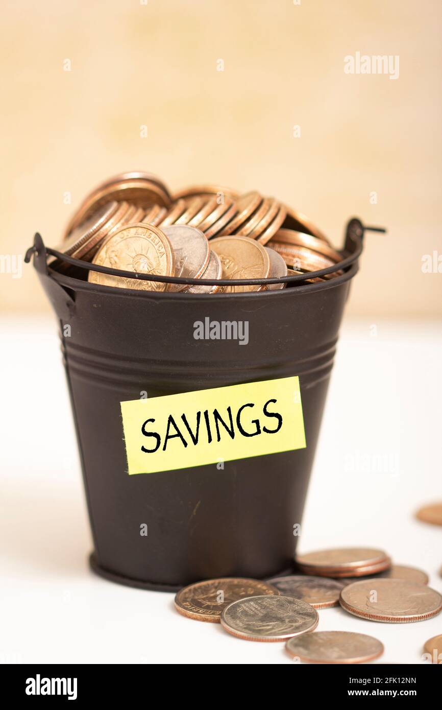 saving coins in bucket Stock Photo - Alamy