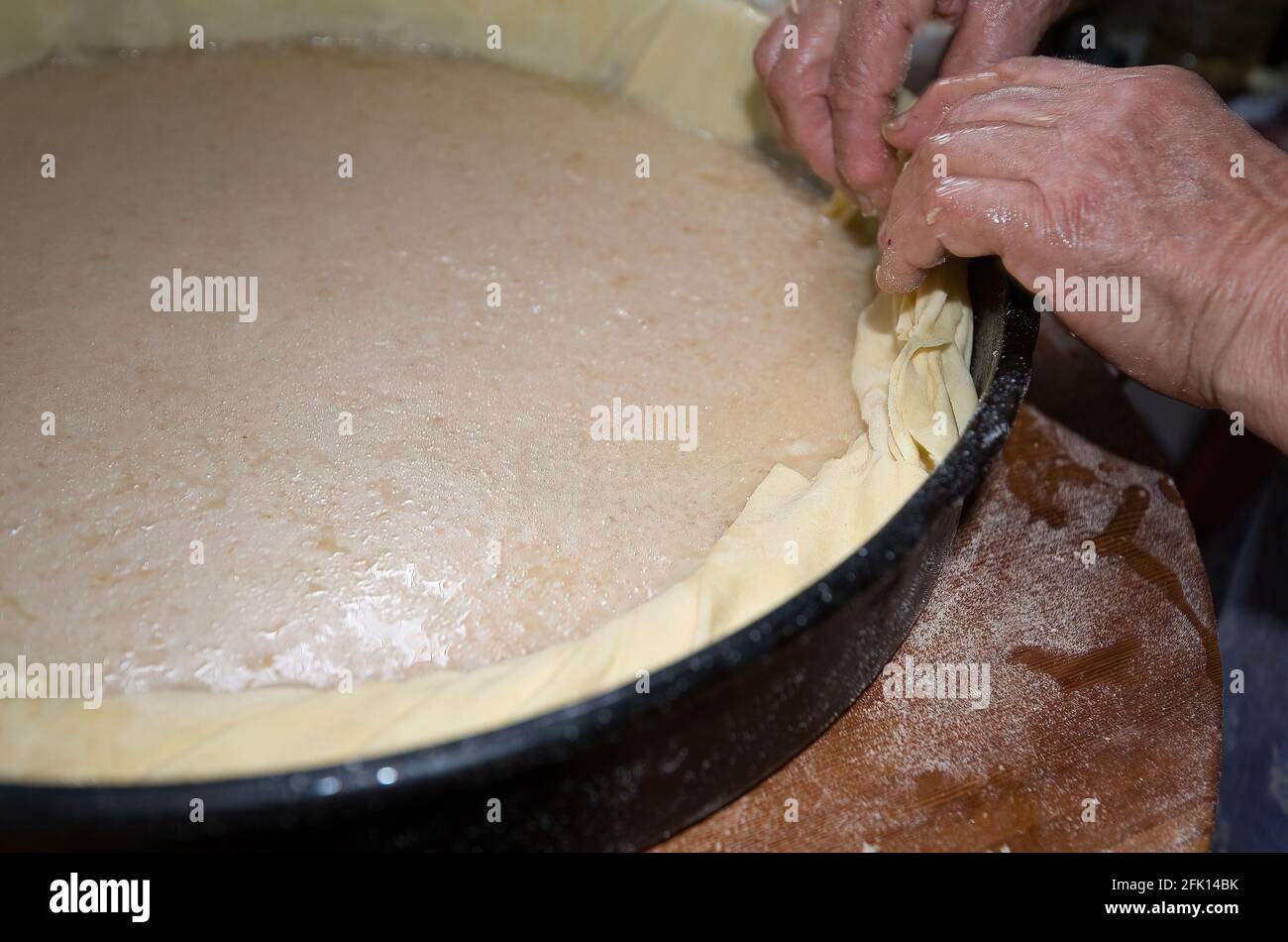 traditional pie with milk, rustic, by an elderly farmer .Greek pie ...