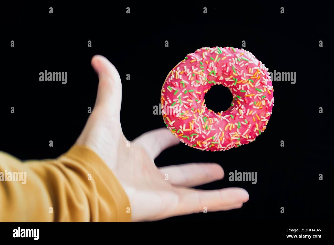 Hand grabbing donut hi-res stock photography and images - Alamy