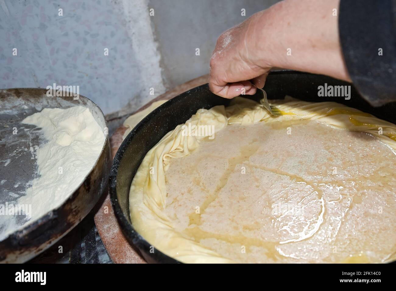 traditional pie with milk, rustic, by an elderly farmer .Greek pie ...