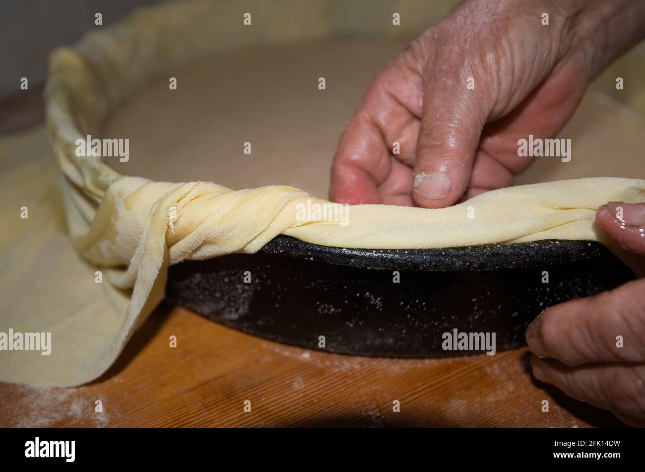 traditional pie with milk, rustic, by an elderly farmer .Greek pie ...