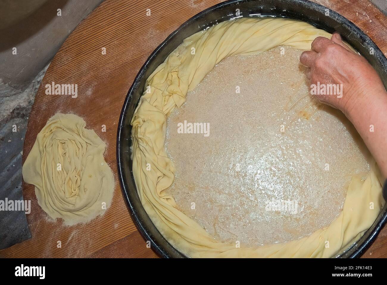 traditional pie with milk, rustic, by an elderly farmer .Greek pie ...