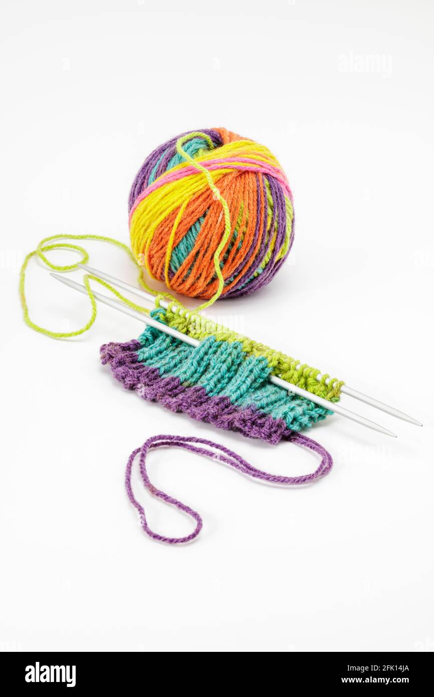 Multi coloured wool with knitting isolated on white background Stock ...
