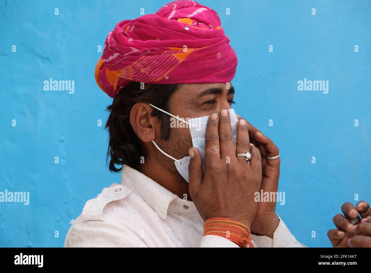 Indian male wearing traditional Indian clothes and a medical mask at a ...