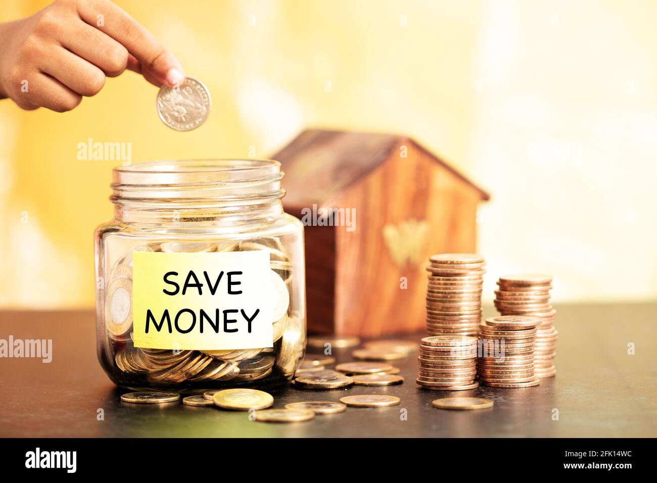 Hand dropping money hi-res stock photography and images - Alamy