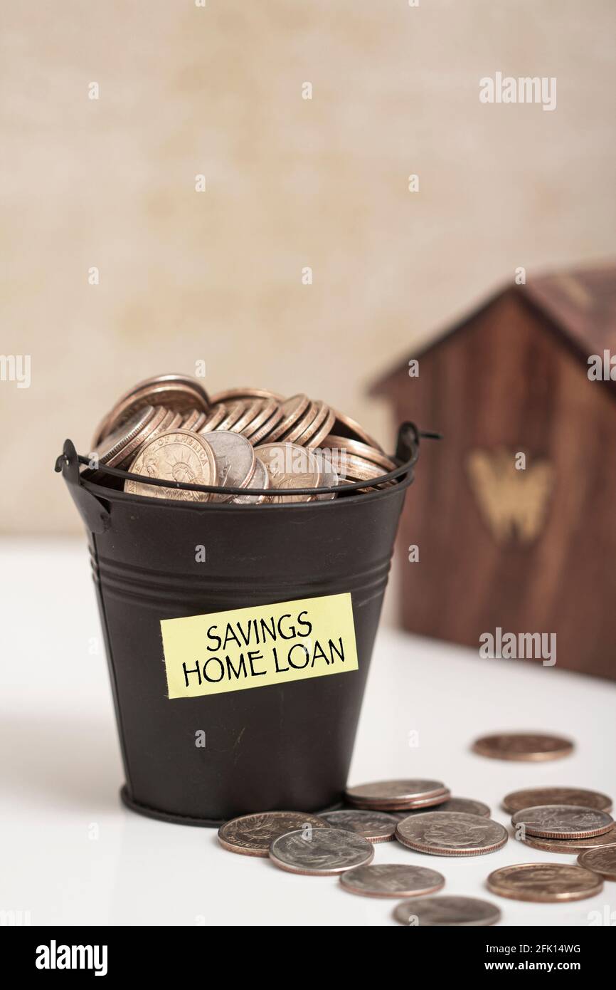 saving for home loan in a bucket with coins Stock Photo - Alamy