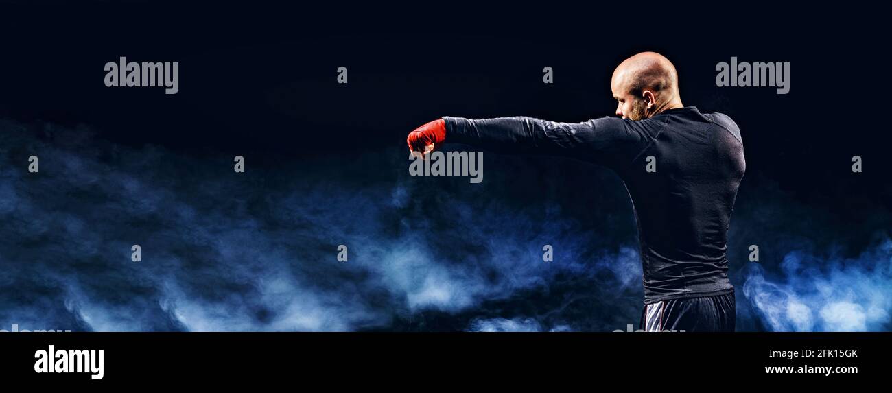 Sportsman boxer fighting on black background with smoke. Boxing Stock ...